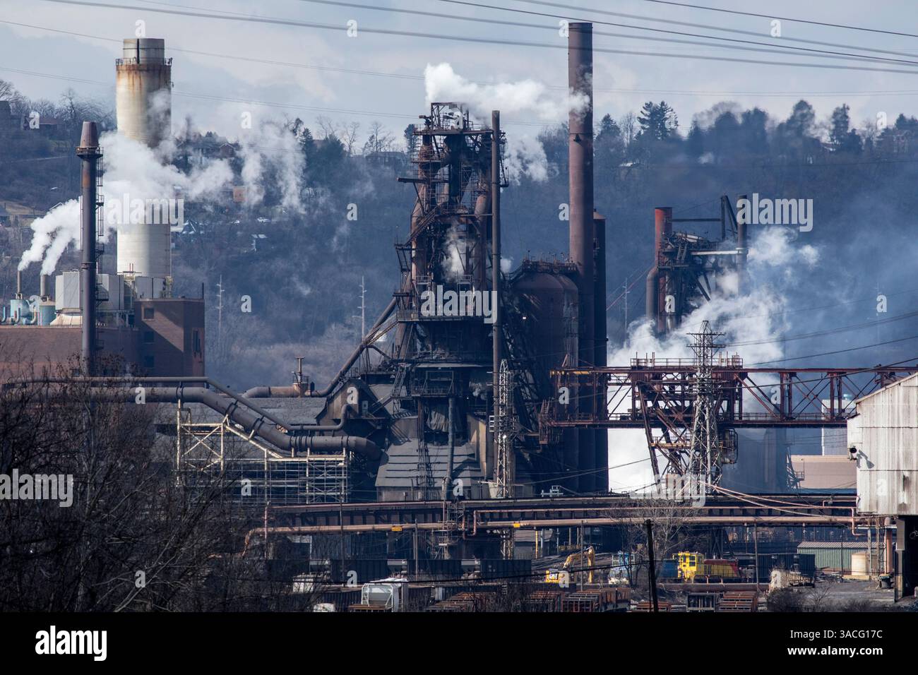 Operating steel mill spewing smoke in the daylight Stock Photo - Alamy