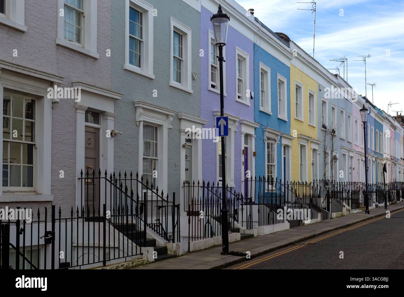 LONDON, UK - MARCH 29, 2025: Colourful painted terraced row of houses ...