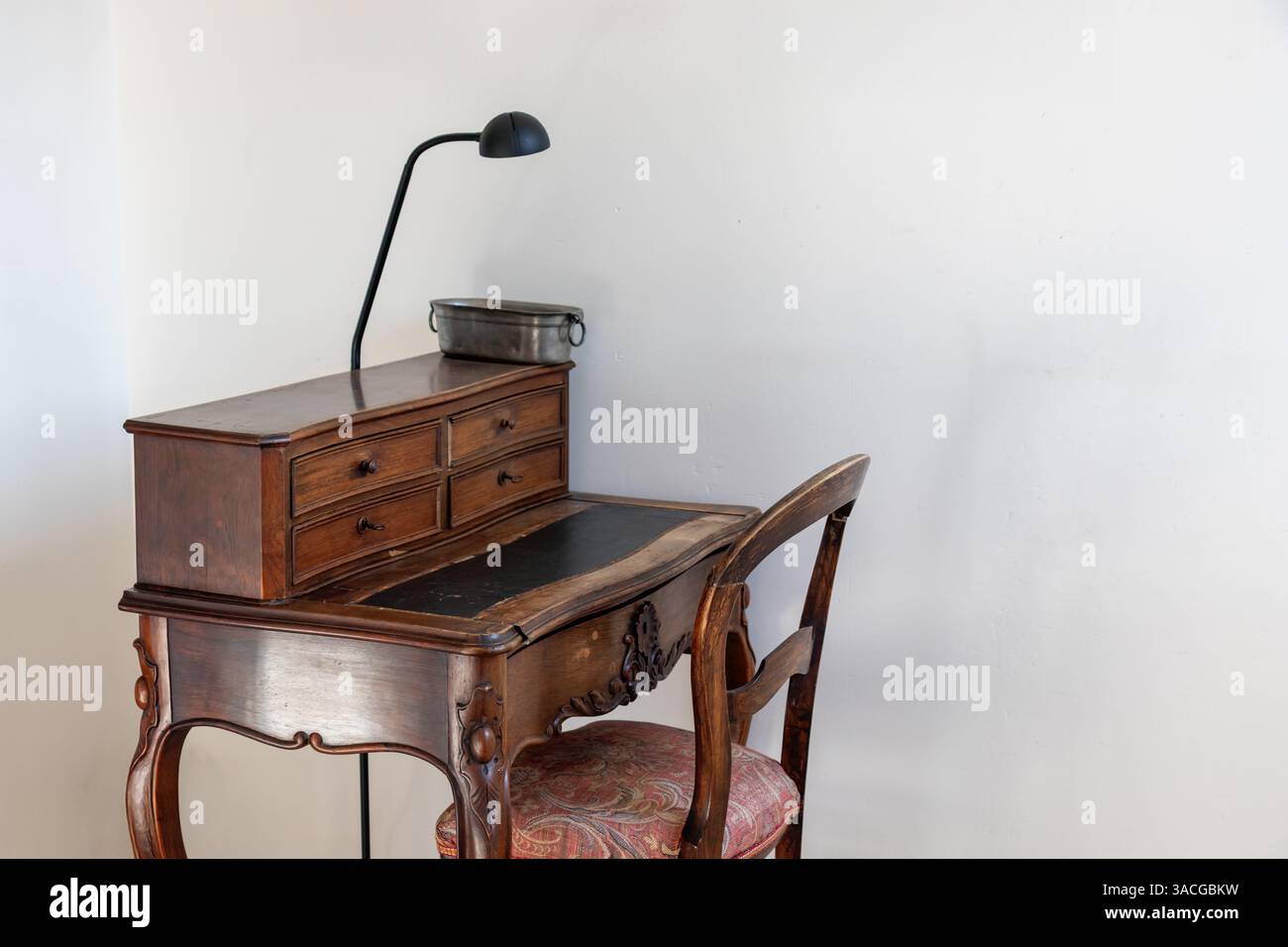 An old vintage brown work desk, wooden table with small drawers and a ...
