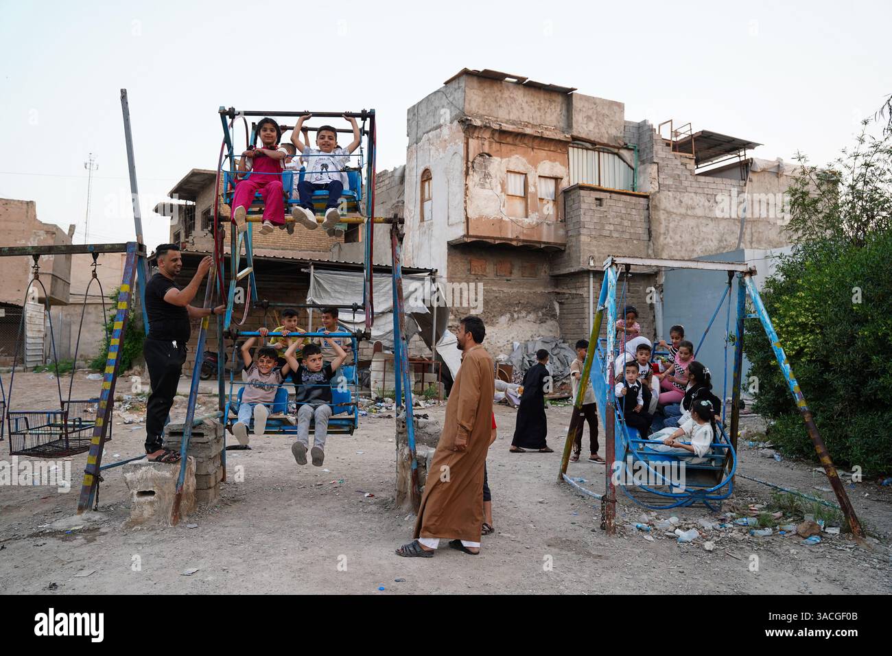 Mosul, Iraq. 02nd Apr, 2025. Iraqi children play on a hand-powered ...
