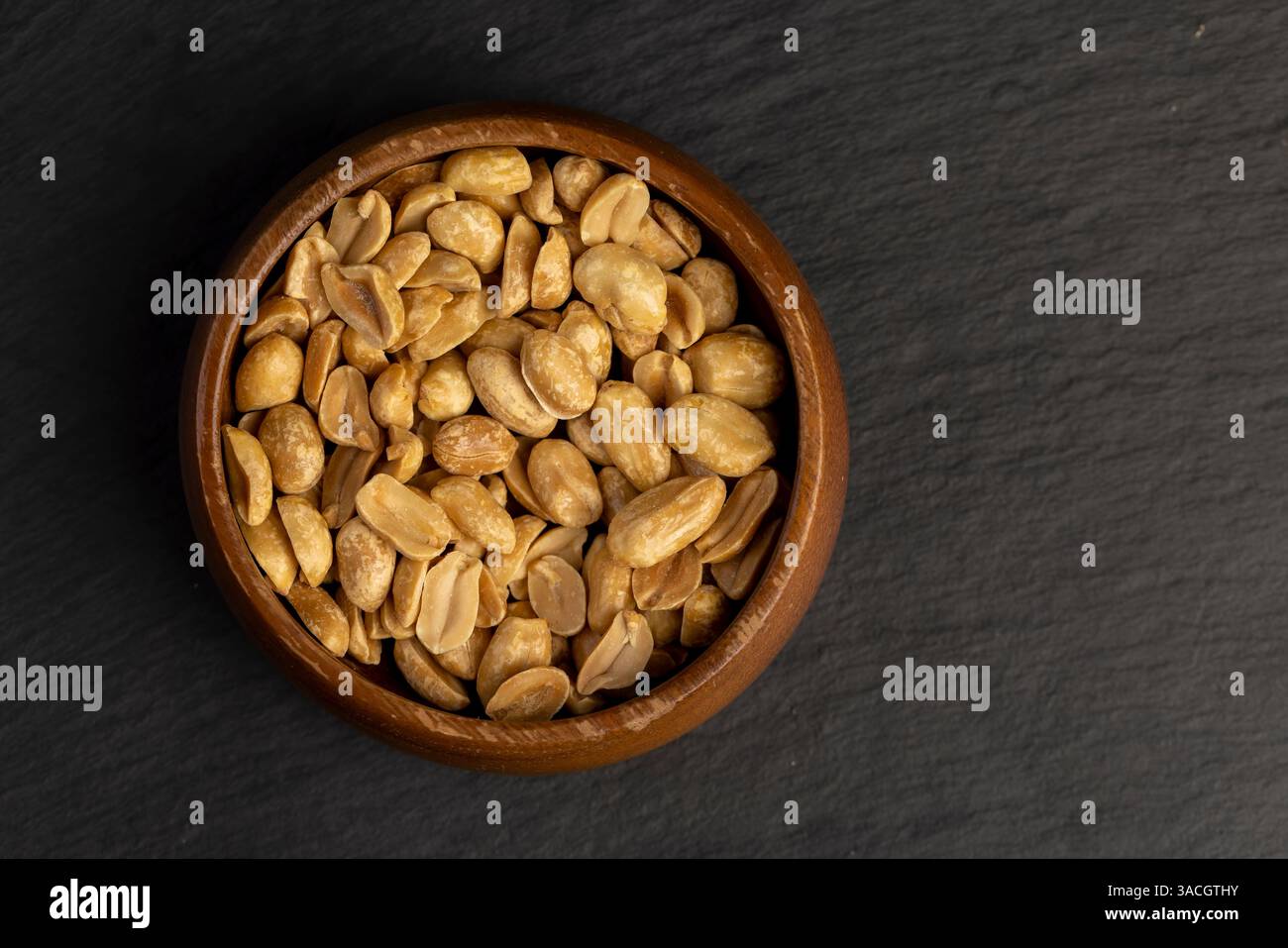 peeled and roasted peanuts in one wooden round bowl, crunchy peanuts ...