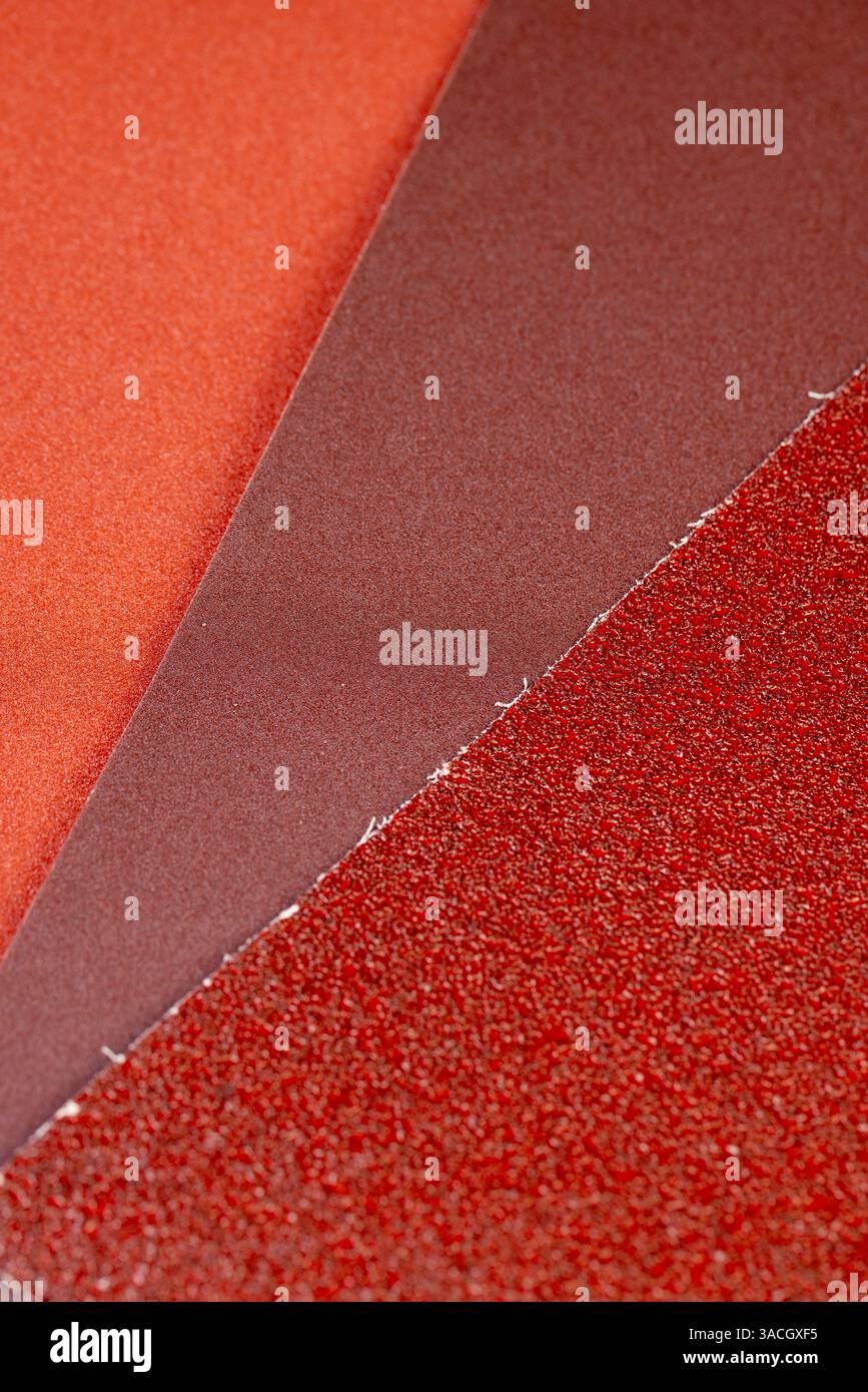 stacked together different types of sandpaper that differ in the size ...