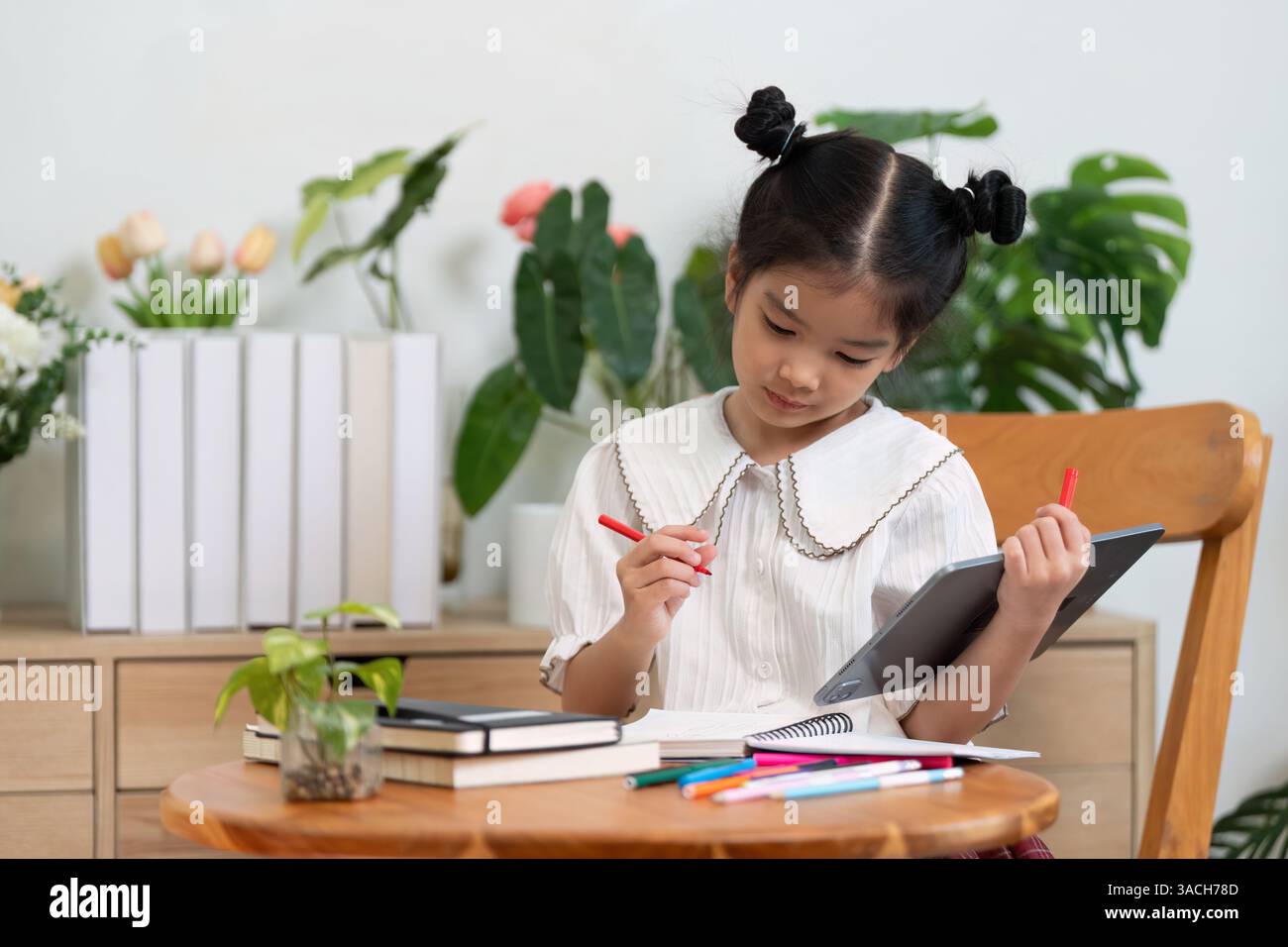 Creativity and Focus. A girl studies with her tools ready ...