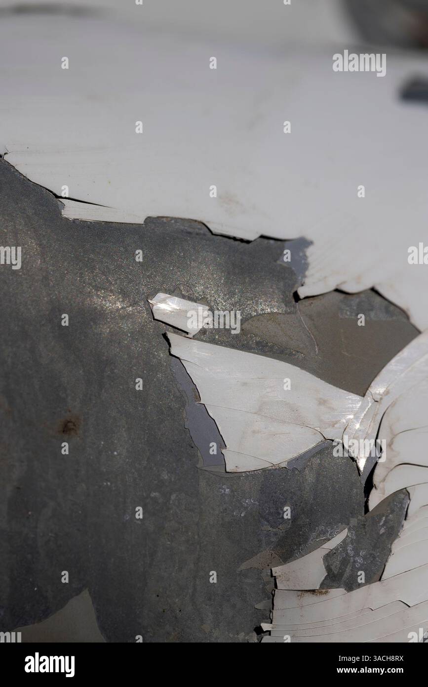 the damaged part of the car body after the accident, the paint is ...