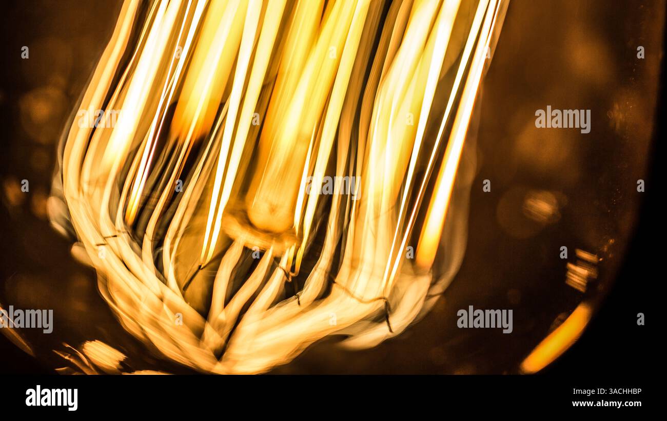 Close-up of Vintage Light Bulb Illuminating in a Warm Hue, Showcasing ...