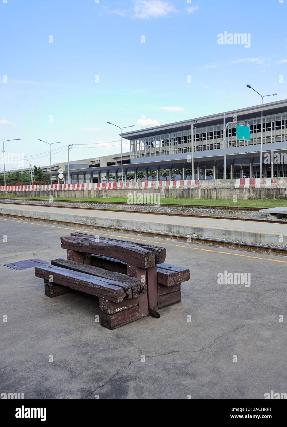 An old wooden bench in Train station background with modern ...