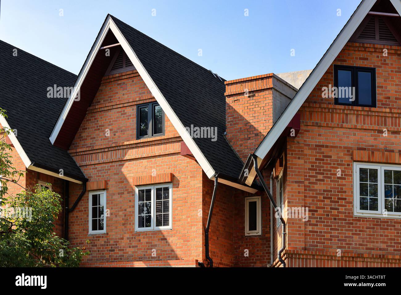 Building made of brick facade with beautiful white wooden windows Stock ...