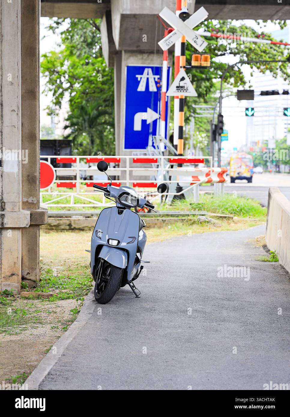 Modern scooter parked on the side of small road Stock Photo - Alamy