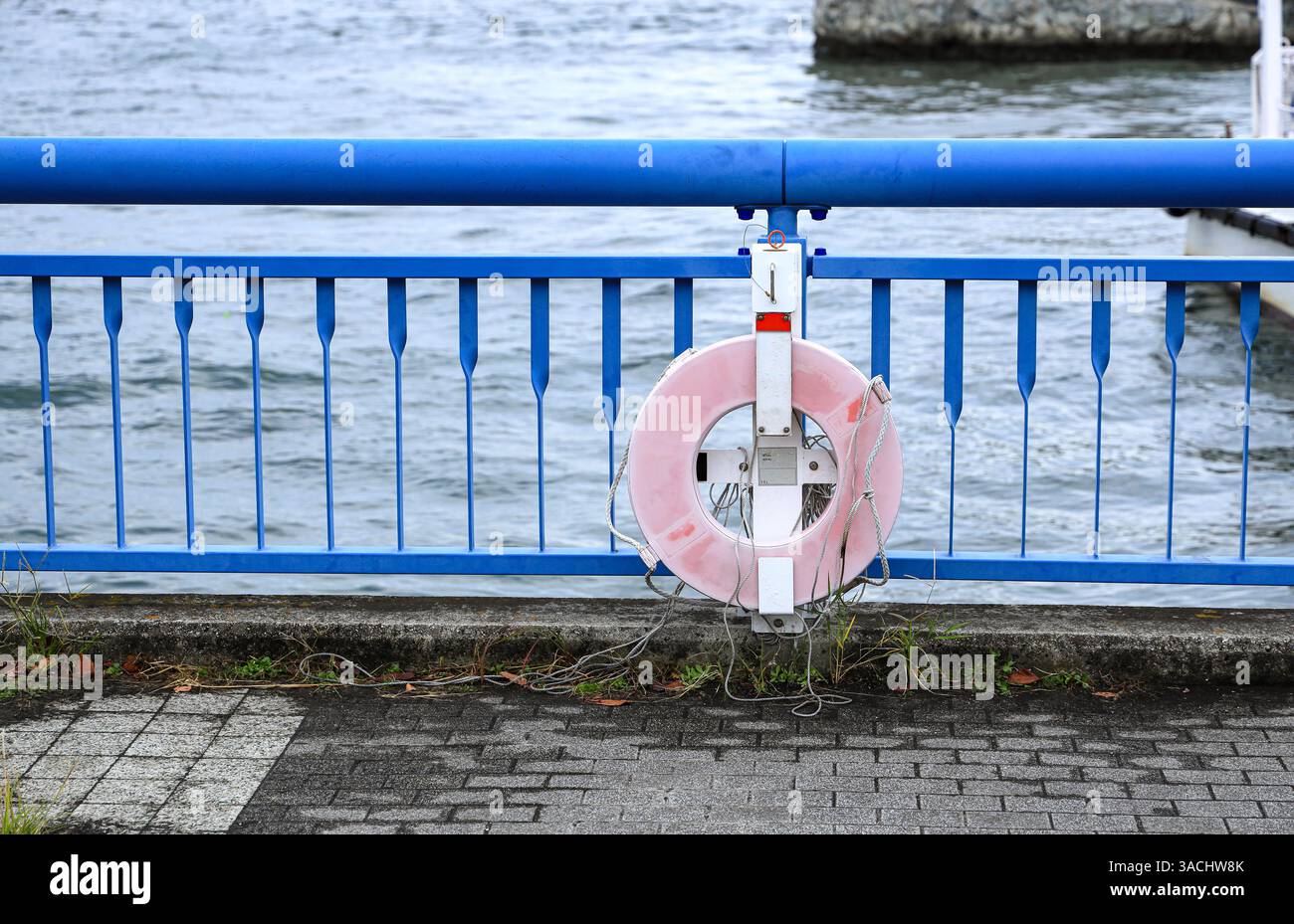 A rescue lifebuoy which installed on riverbank corridor railing, stand ...