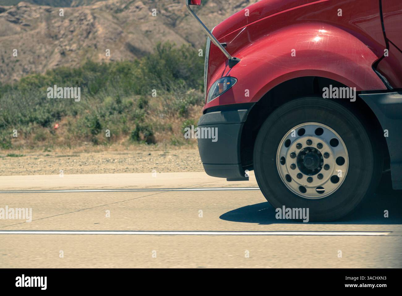 Commercial truck wheel rotating on paved road surface. Heavy-duty truck ...