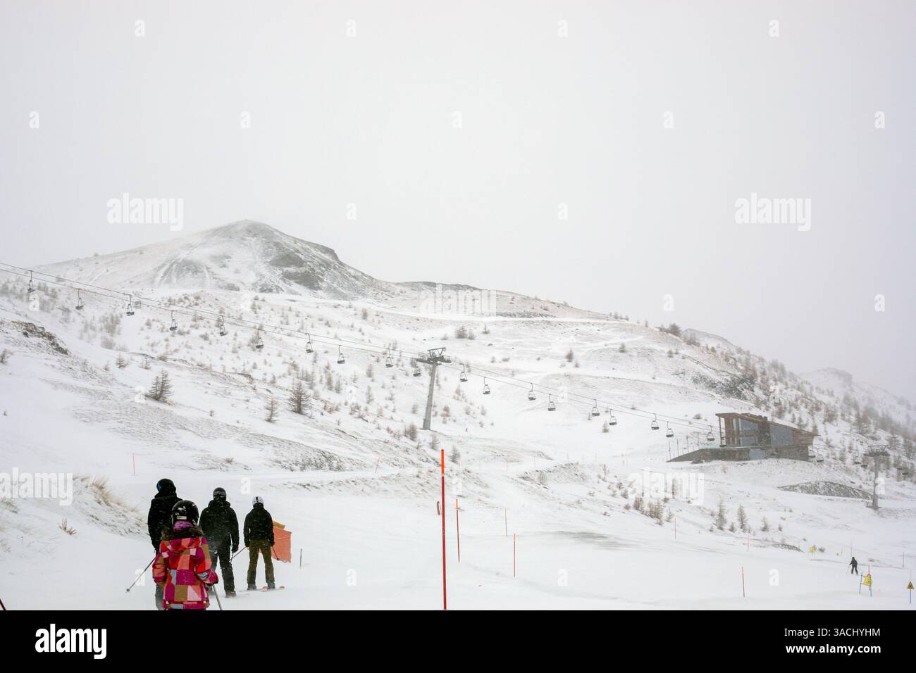 fog and snow on the top of a ski slope with reflective signs. Active ...