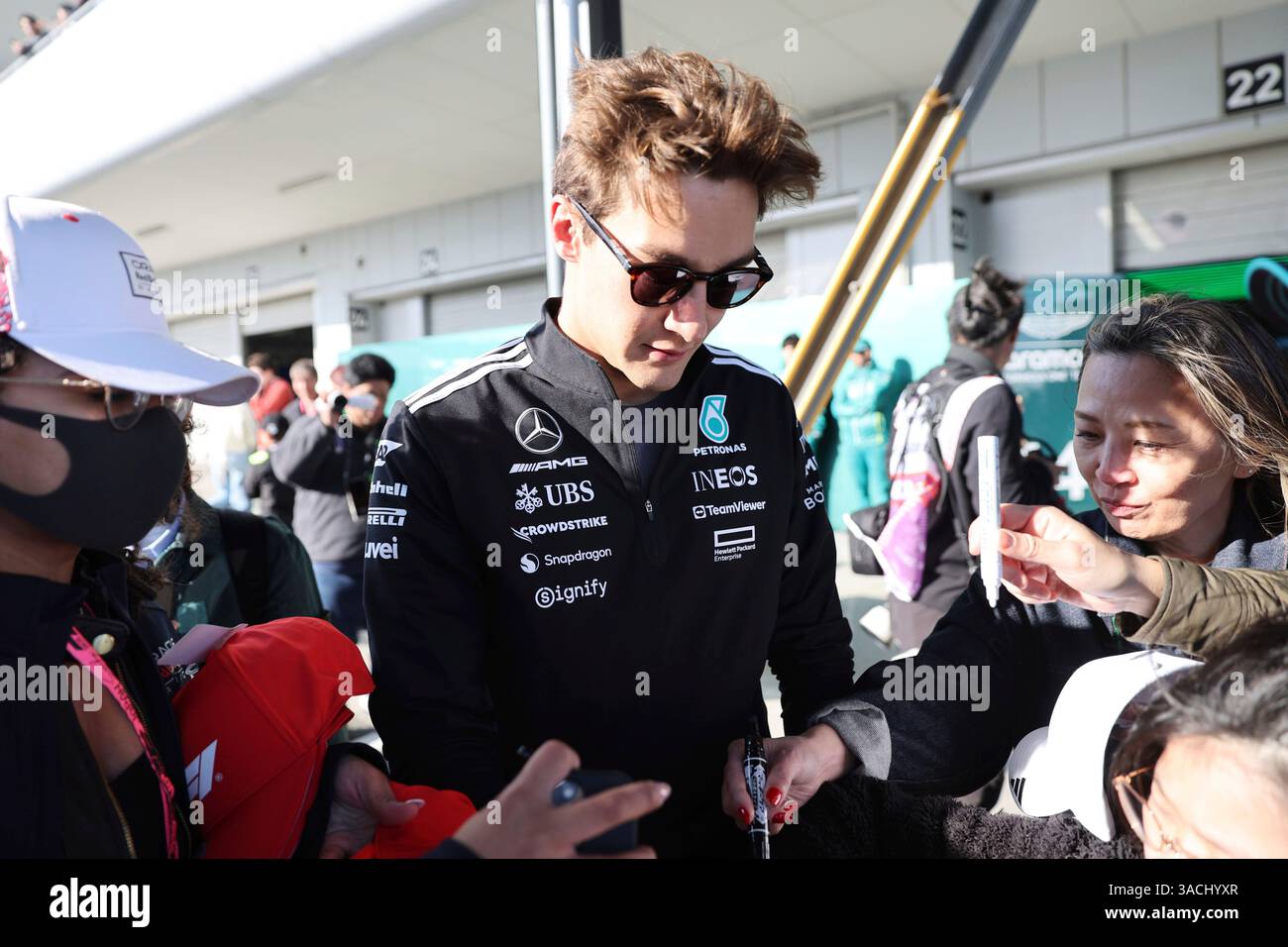 George Russell of the United Kingdom and Mercedes writes his autographs ...