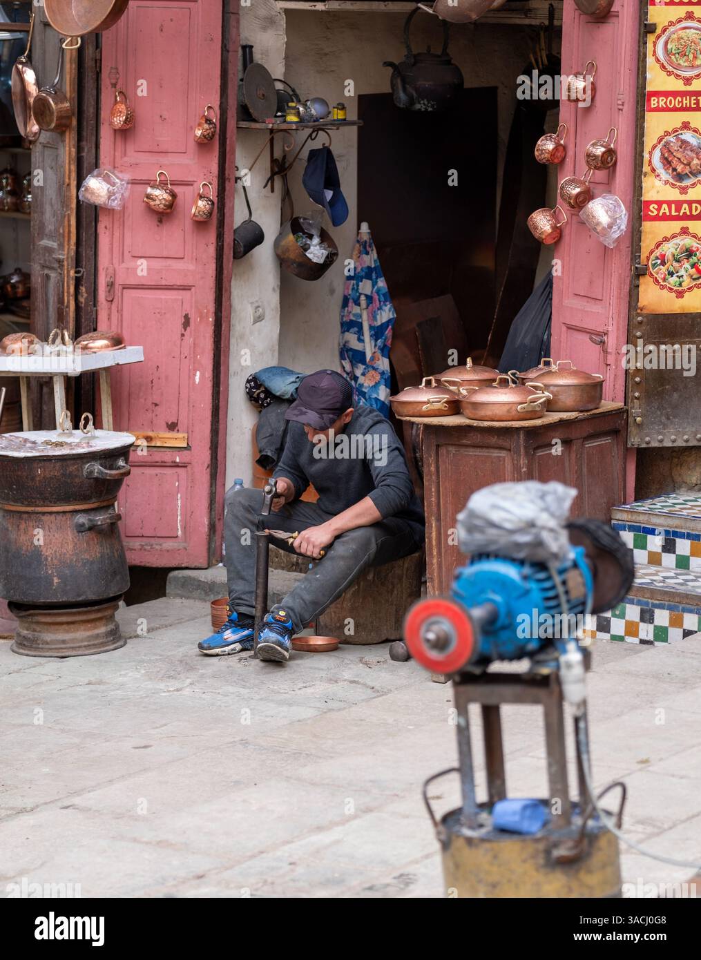 Craftsman blacksmith works in workshop in restored restored Place ...