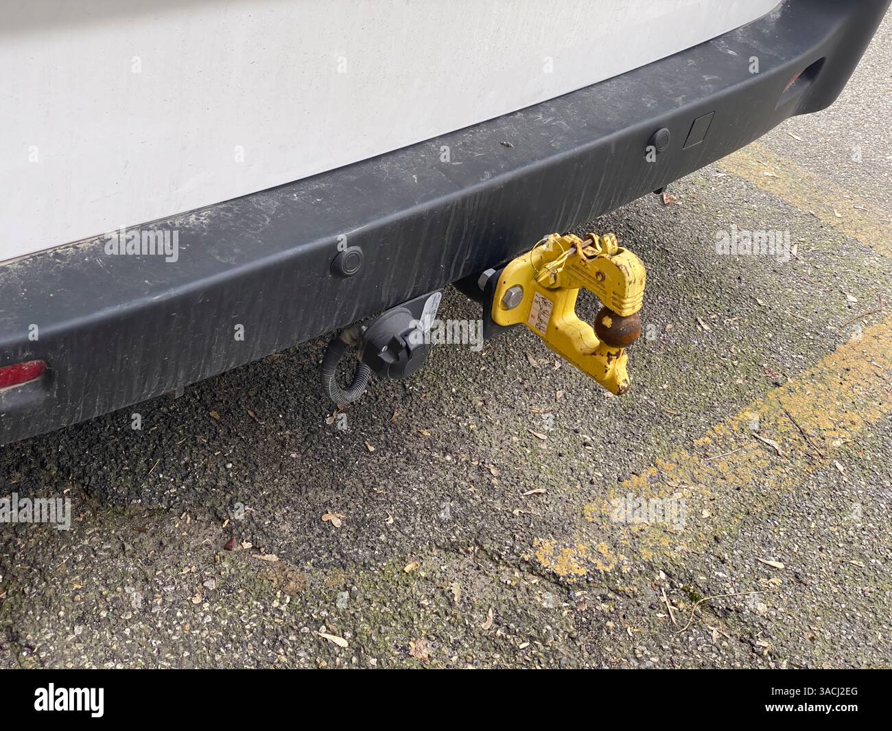 Crema, Italy - March 2nd 2025 Close up of a yellow tow hitch attached ...