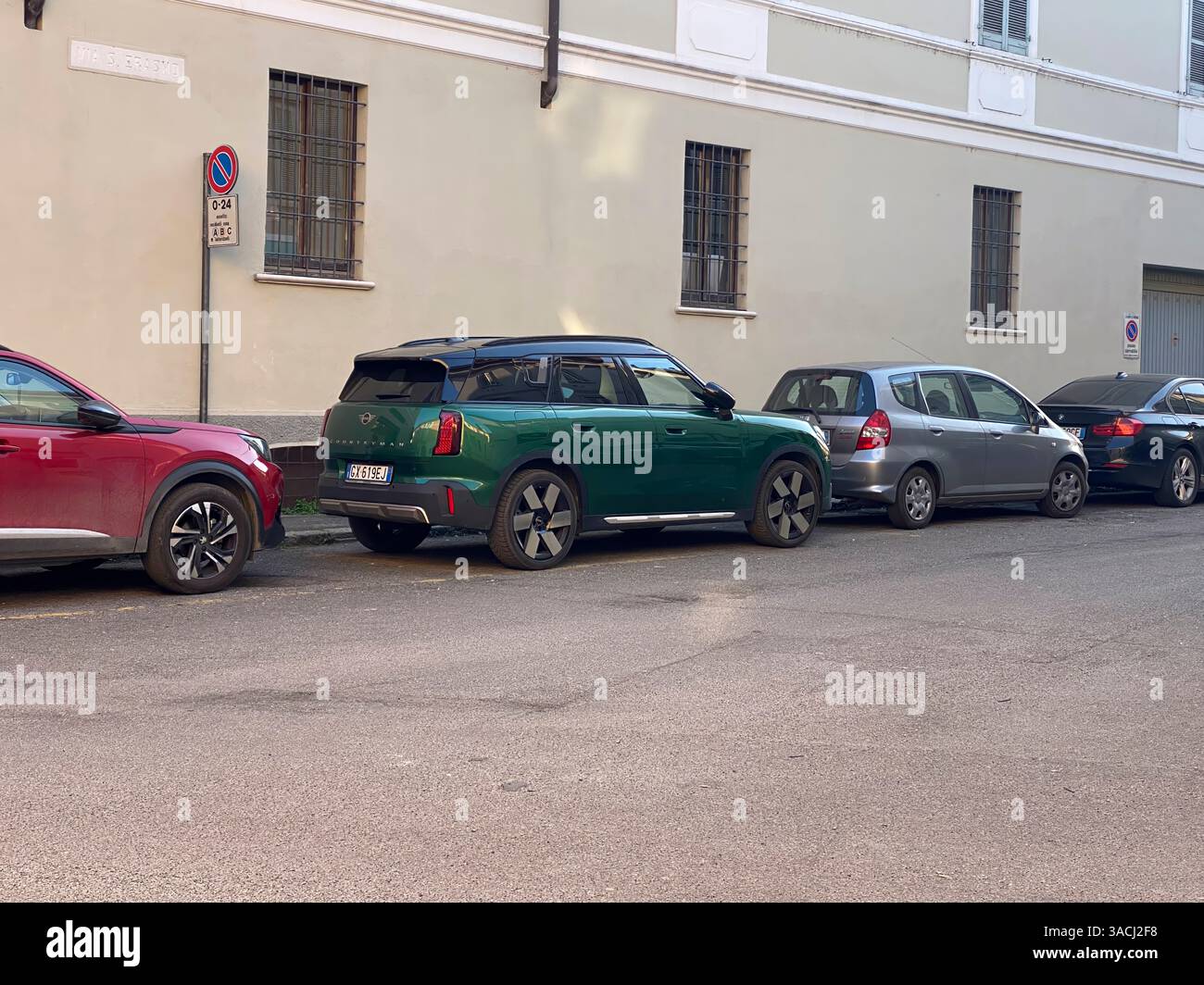 Crema, Italy - March 2nd 2025 Parked cars lining the street city center ...