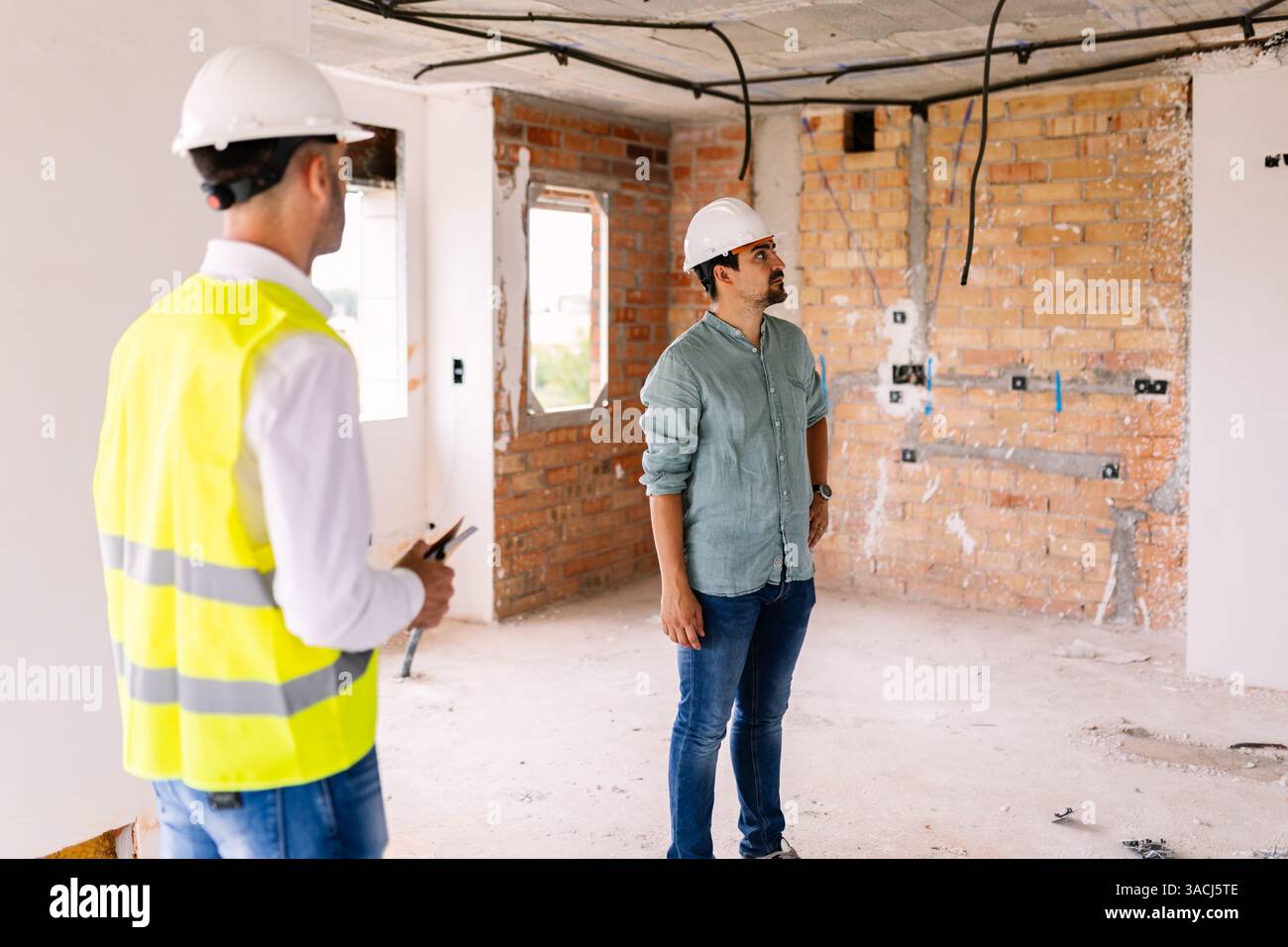 Engineers inspecting construction site progress and planning next steps Stock Photo - Alamy