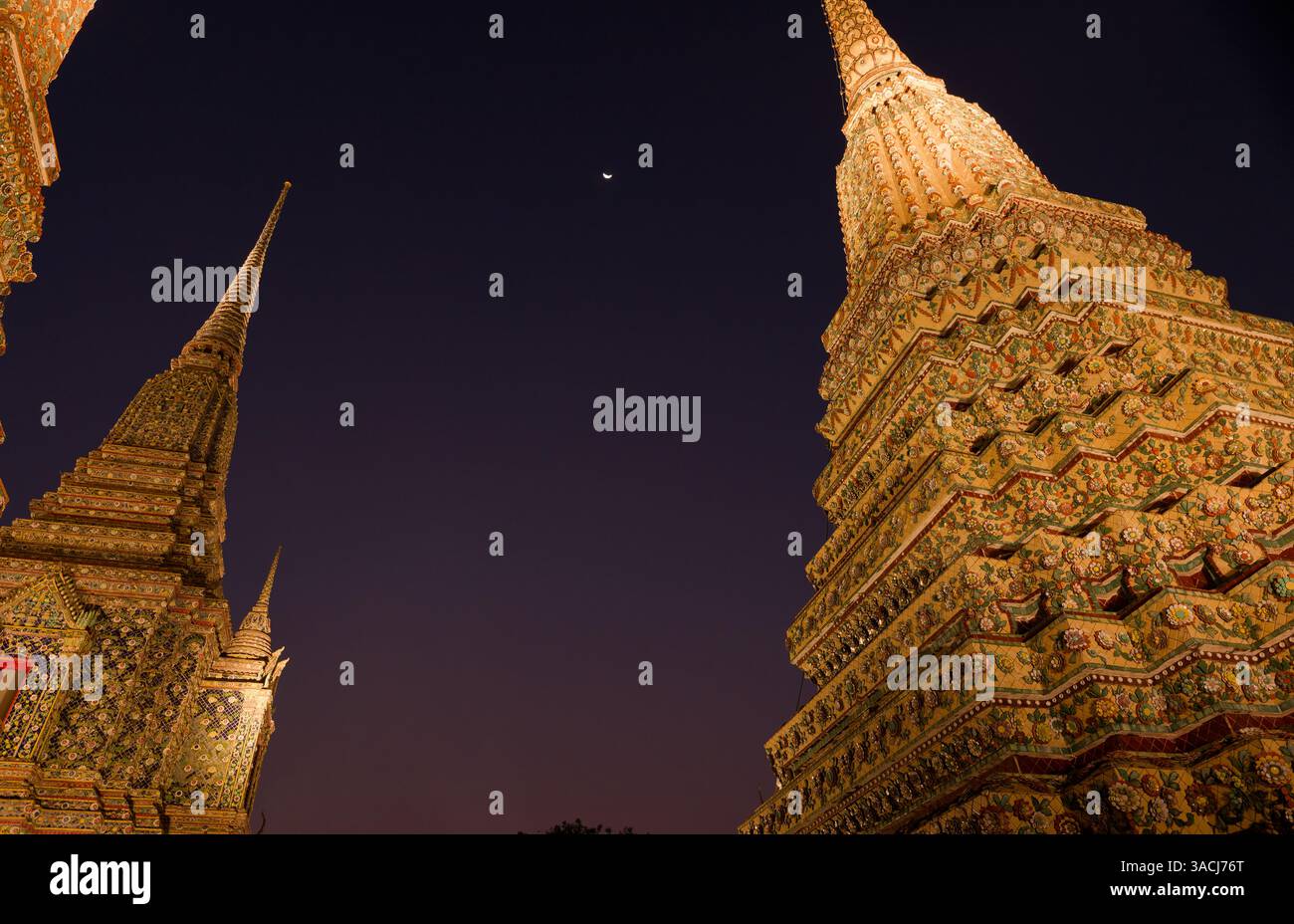 Golden stupas of Wat Pho glow under a crescent moon Stock Photo - Alamy