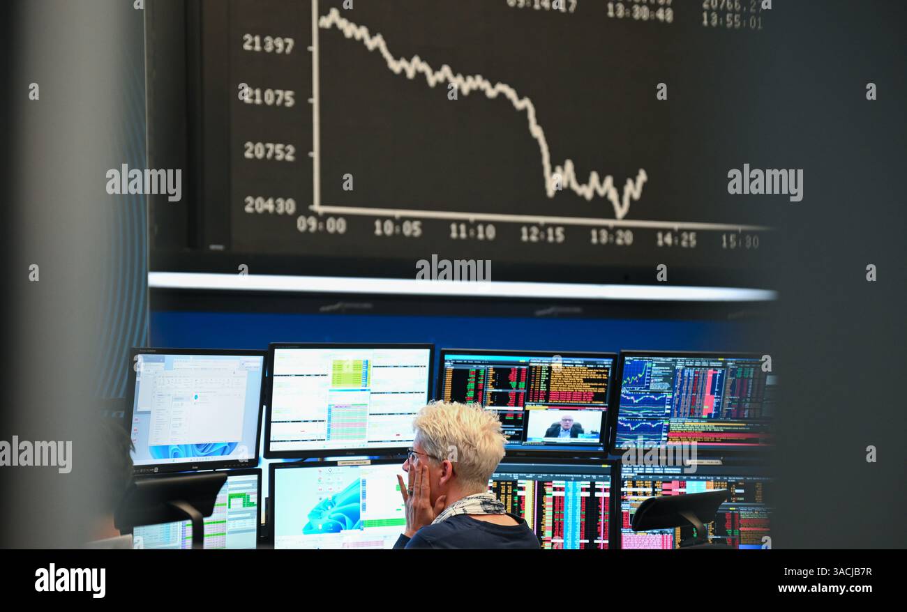 04 April 2025, Hesse, Frankfurt/Main: A stock exchange trader watches ...