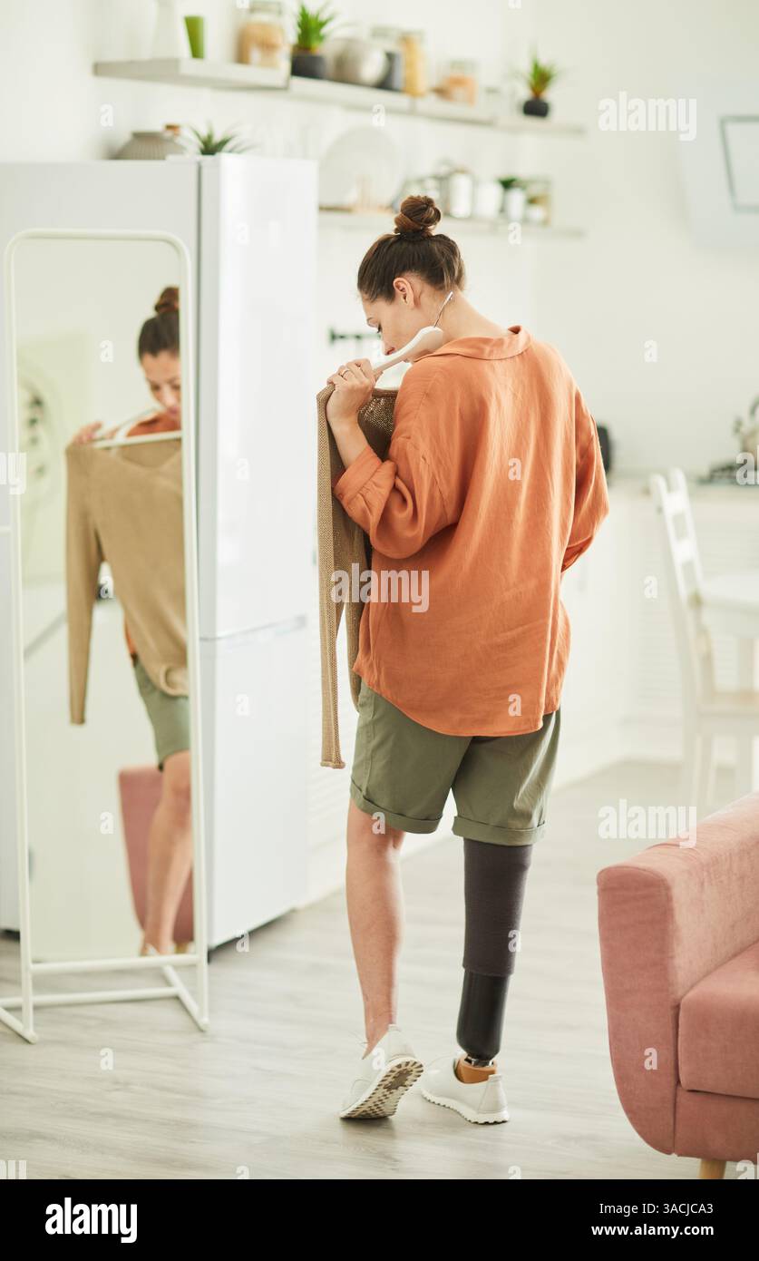 Vertical back view portrait of modern woman with disability looking in ...