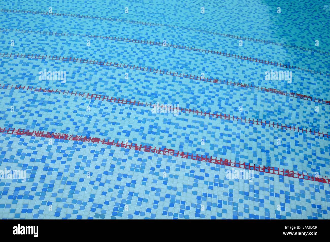 Lanes with marking on bottom in a swimming pool with clean blue water ...