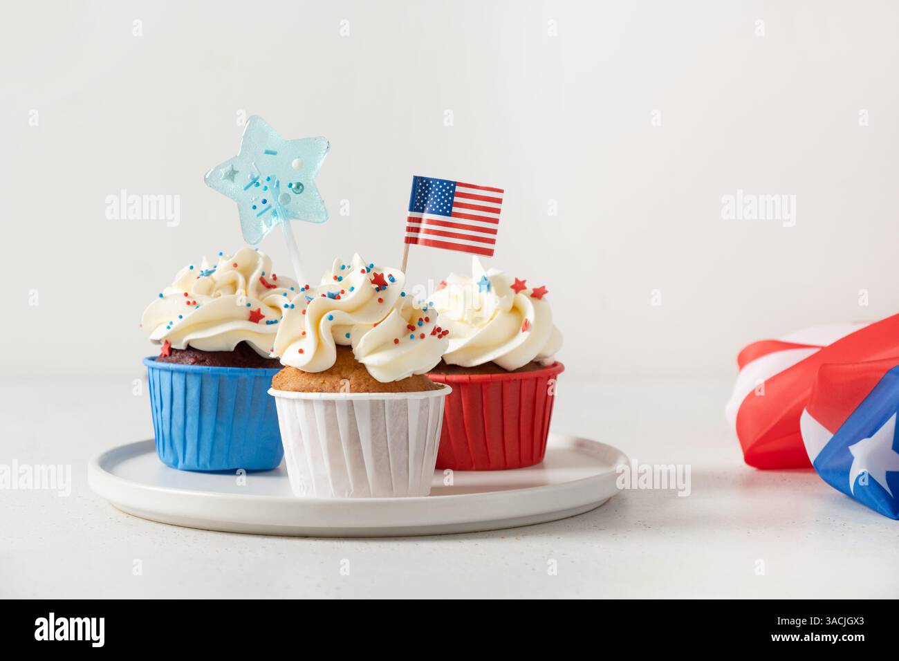 Traditional American sweet cupcakes with festive stars and USA flag on ...