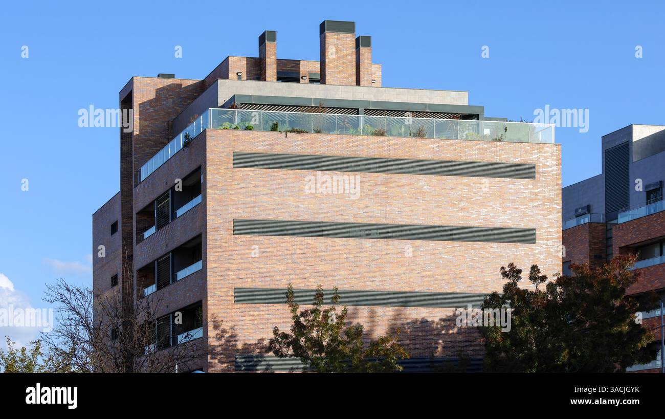 Contemporary urban architecture featuring a brick facade, balconies ...