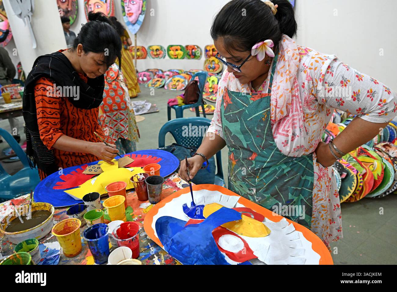 Student of Faculty of Fine arts of Dhaka University painting masks for ...