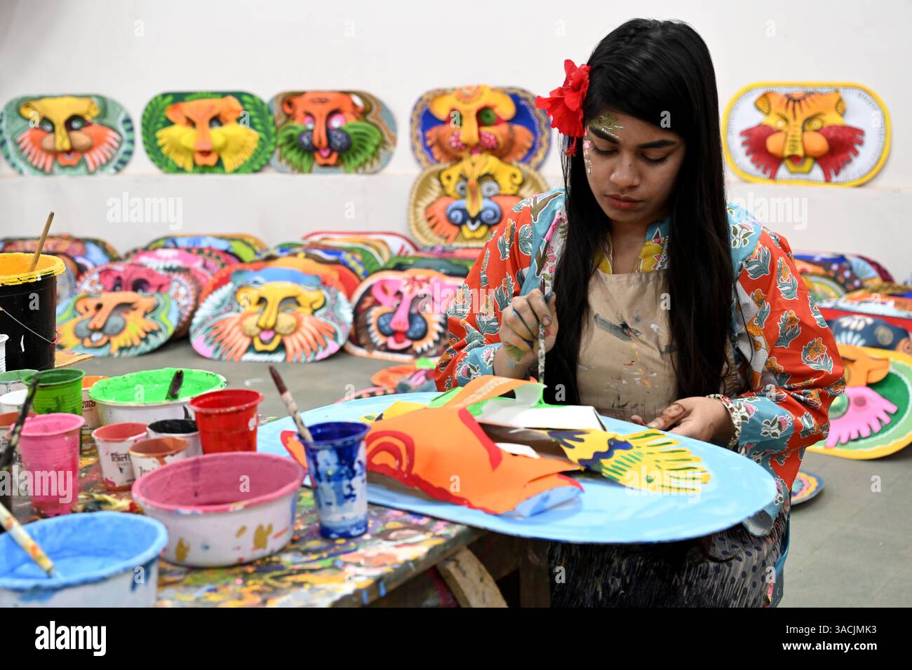 Student of Faculty of Fine arts of Dhaka University painting masks for ...