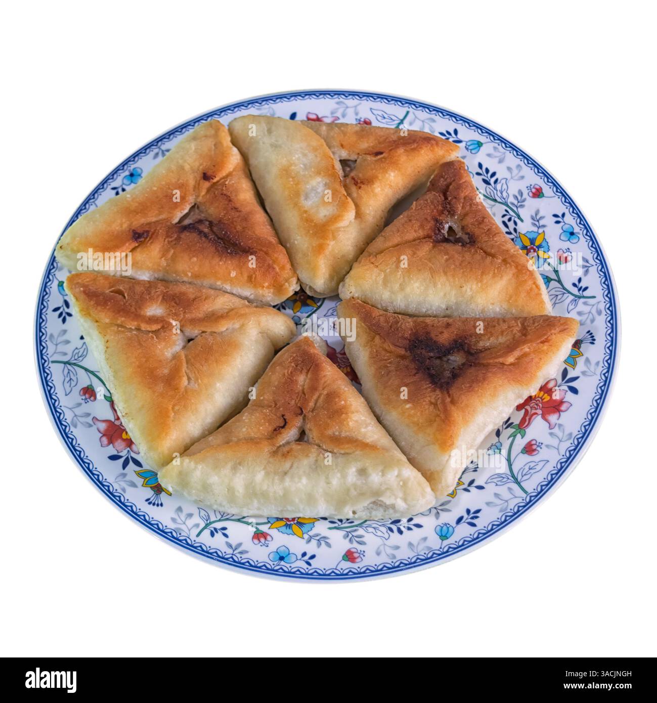 Triangular fried pies with chicken meat and onions on a platter isolate ...