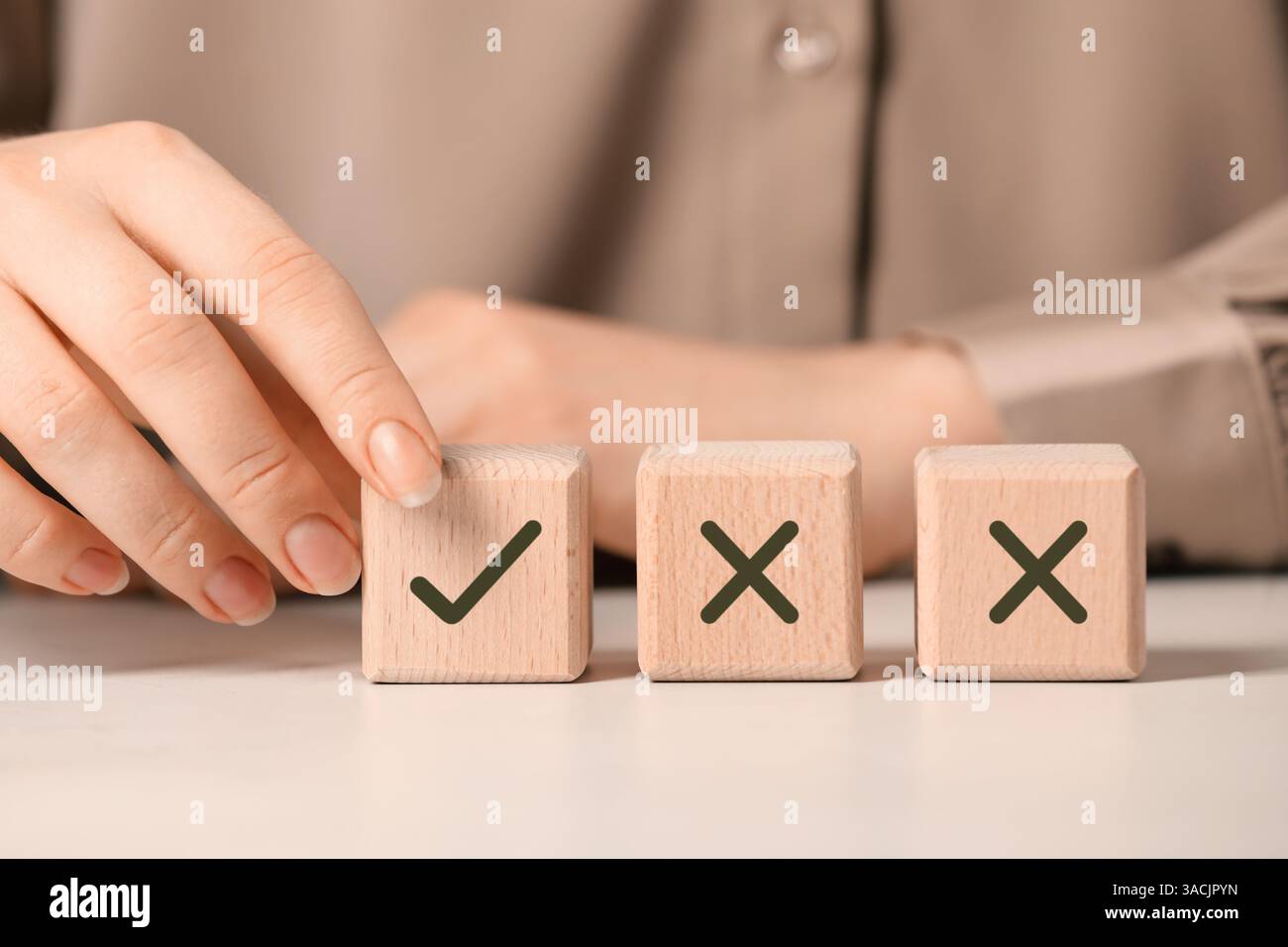 Approved. Woman choosing cube with check mark among other ones with ...