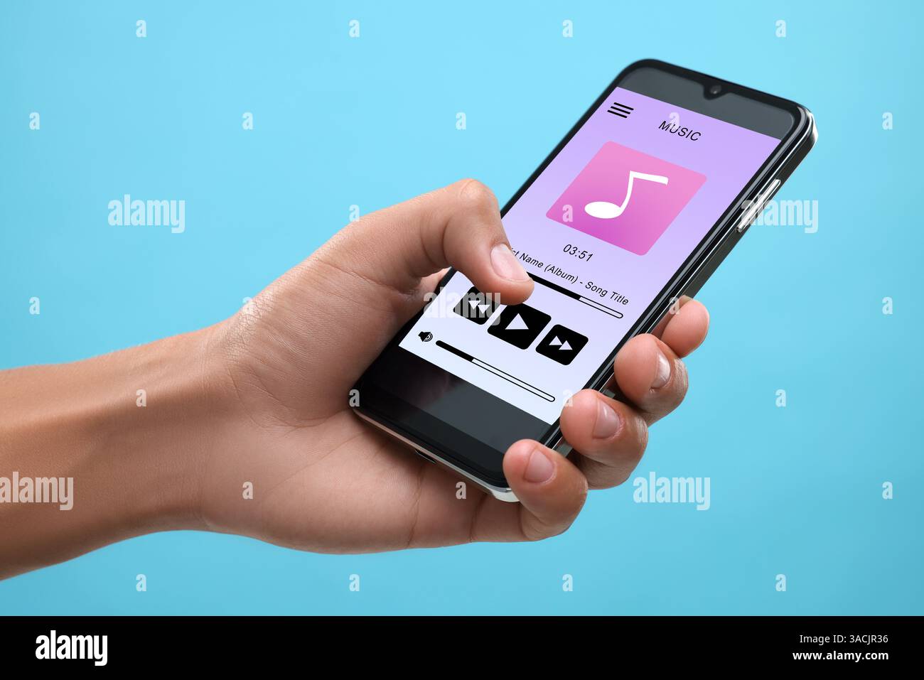 Man using mobile phone to listen to music on light blue background ...