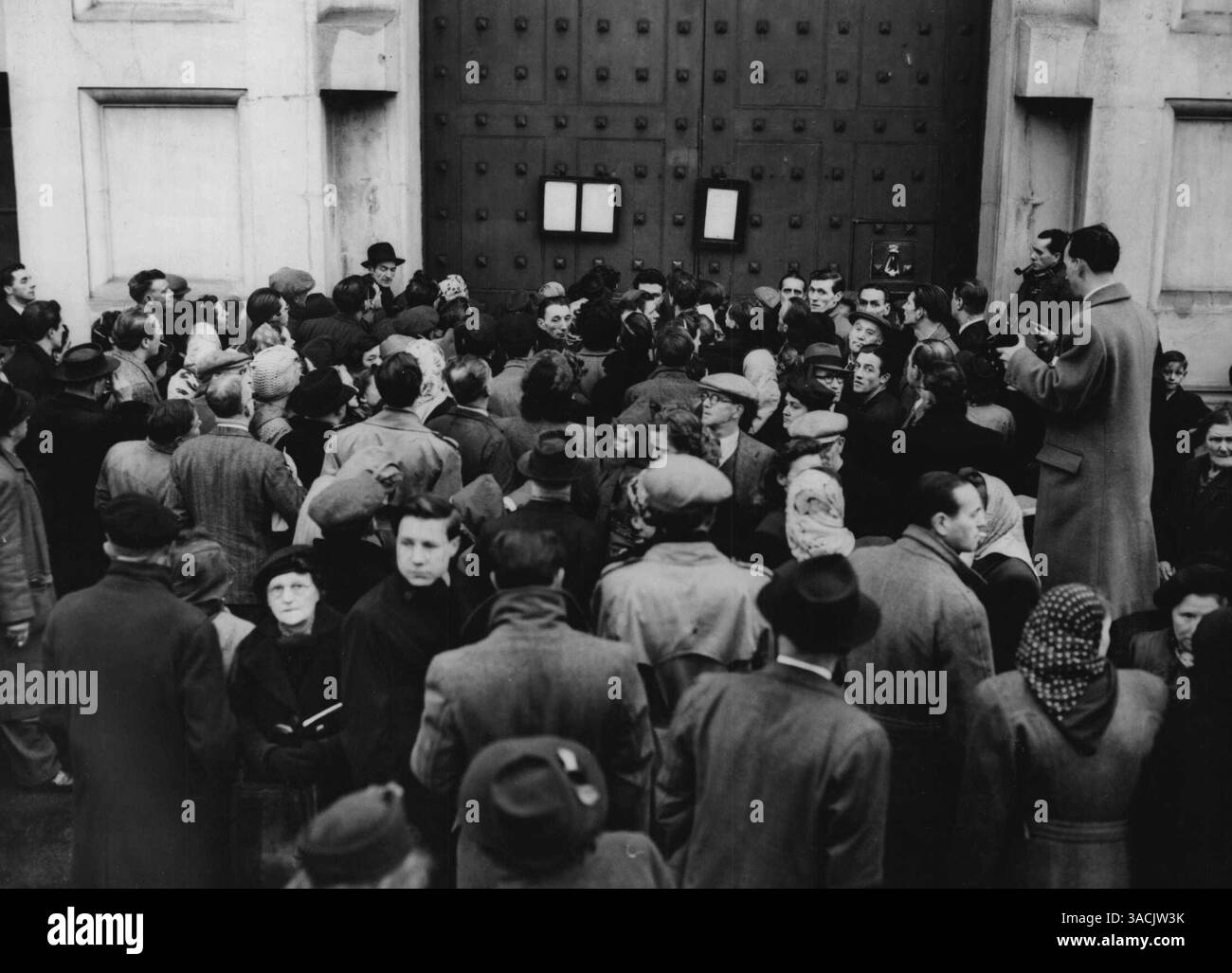 Daniel Raven Hanged - A crowd of people press forward to read the ...