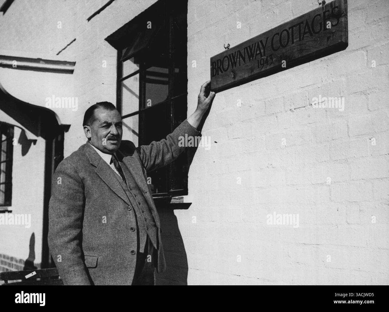 Opening of Farm Workers Cottages. Photo Shows: Mr.Ernest Brown hanging ...
