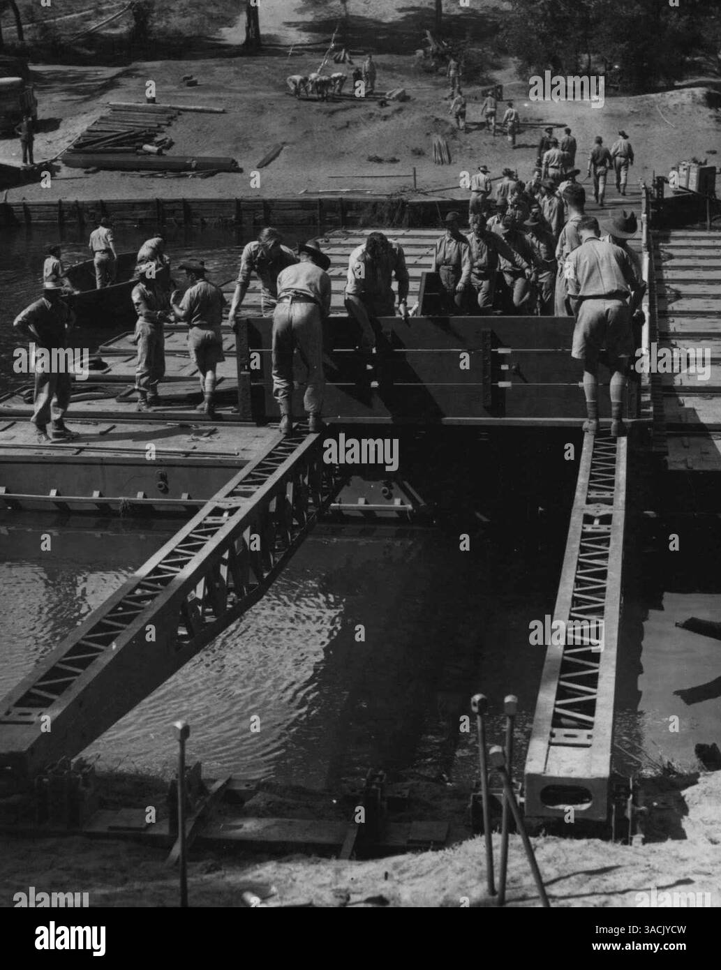 Bridge Holds Heavy Load -- Skilful hands building a pontoon bridge over ...
