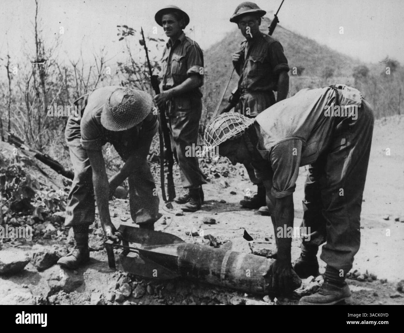 British Troops Take Mount Popa -- British sappers unearthing a 250lb ...