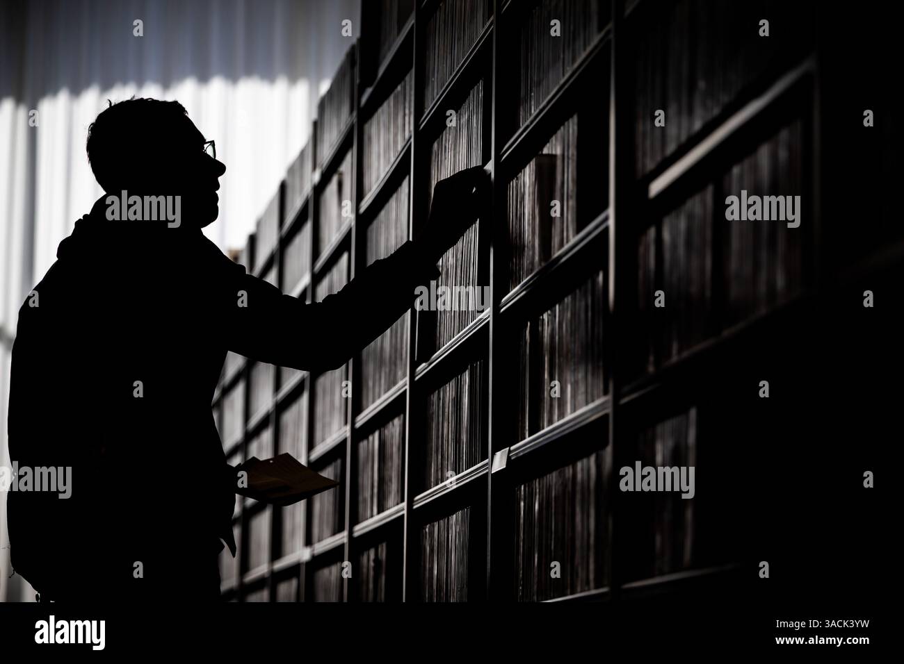 Berlin, Germany. 04th Apr, 2025. A man reaches into a shelf in the ...