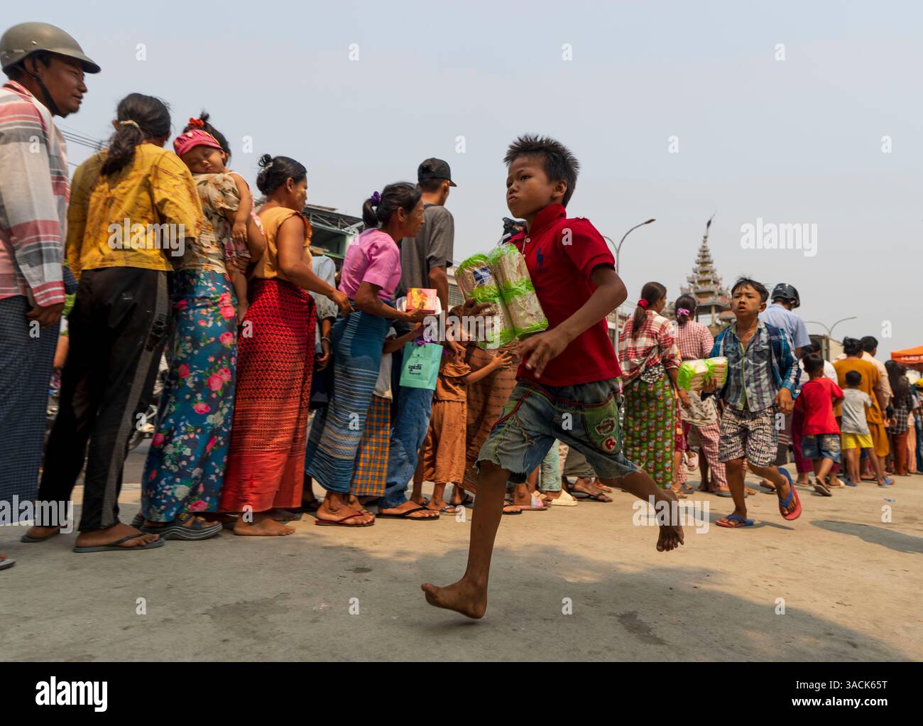 Mandalay, Myanmar. 4th Apr, 2025. A child receives food at a temporary ...