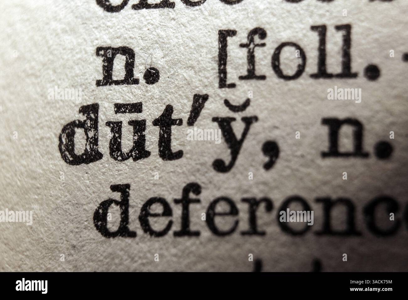 Word duty on dictionary page, macro close-up Stock Photo - Alamy