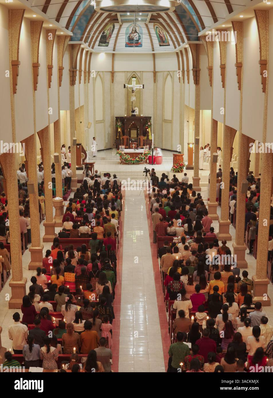 Worshippers gather for a solemn mass inside a historic church with warm ...
