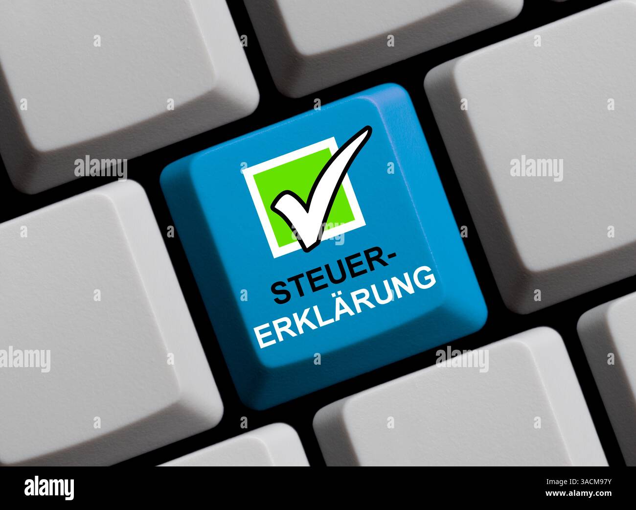 Computer keyboard with check mark shows tax return Stock Photo - Alamy