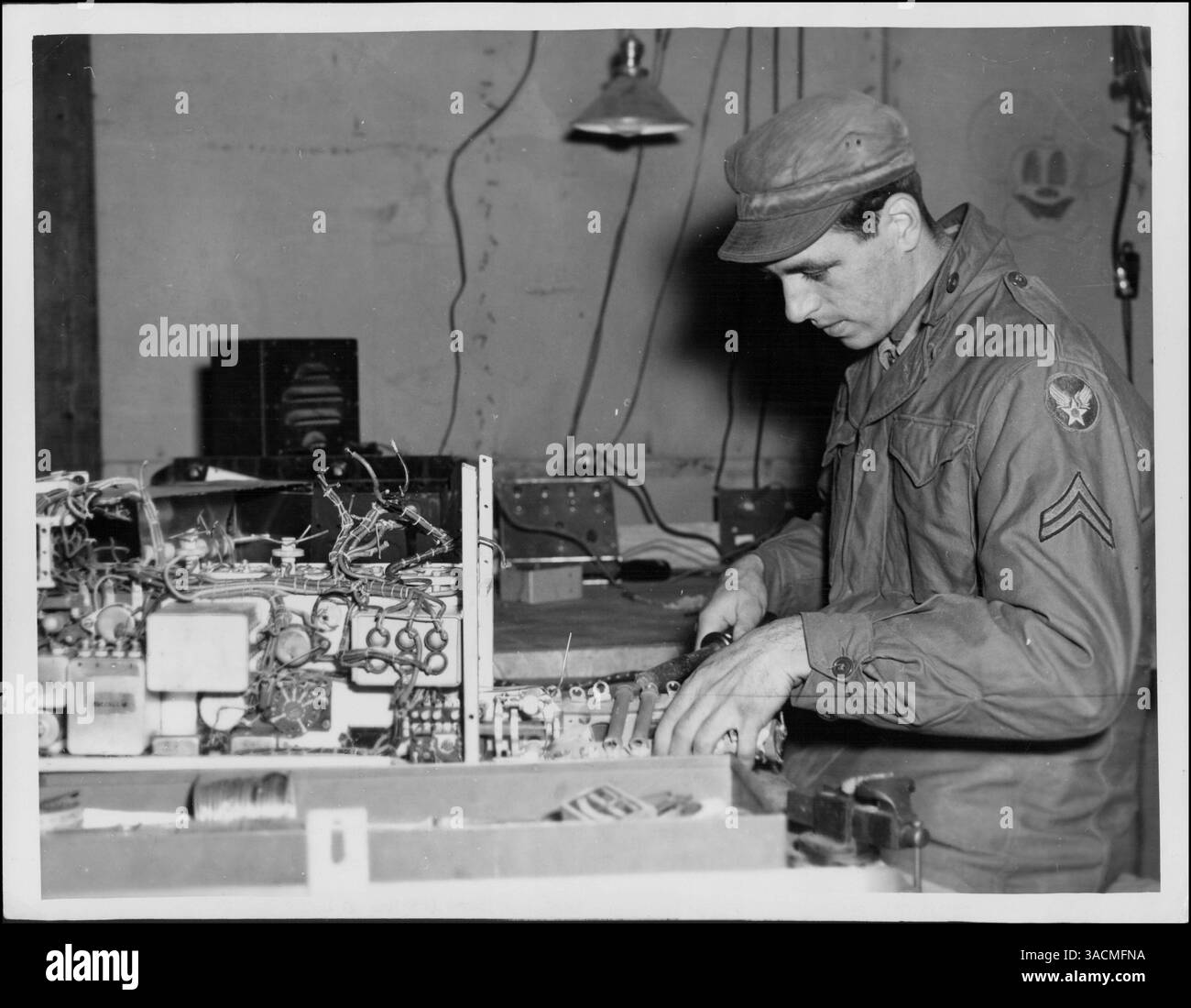 Corporal Donald T. Meilsle, stationed in Italy, is seen disassembling a ...