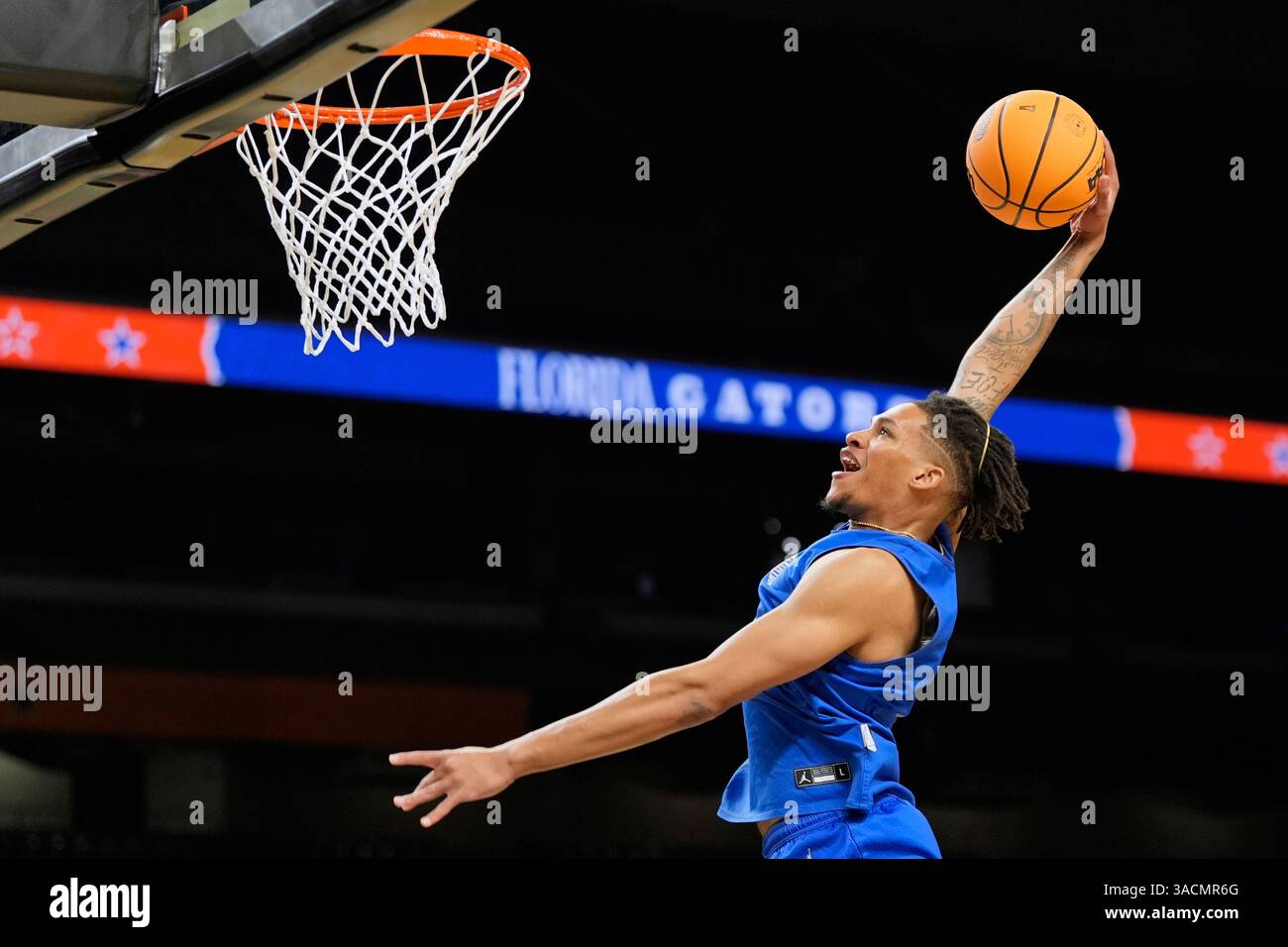 Florida guard Will Richard dunks during practice at the Final Four of ...