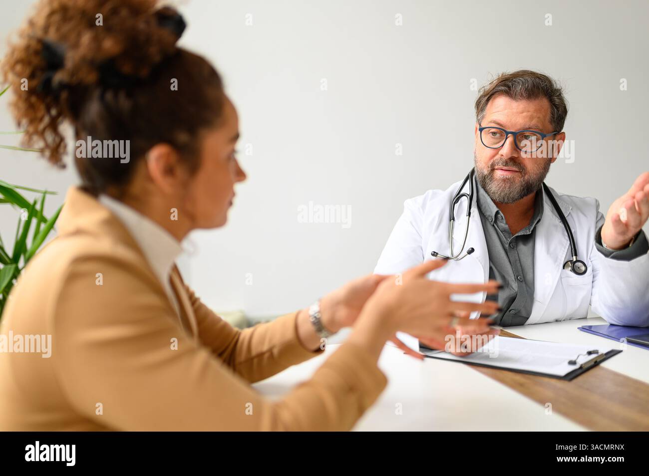 Serious male doctor guiding hi-res stock photography and images - Alamy