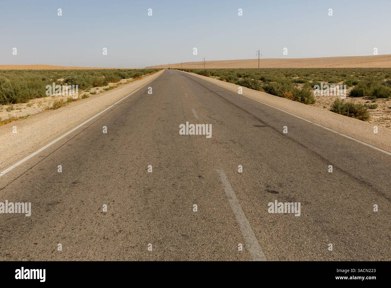 Wide open road stretches through the arid landscape of Faryab Province ...