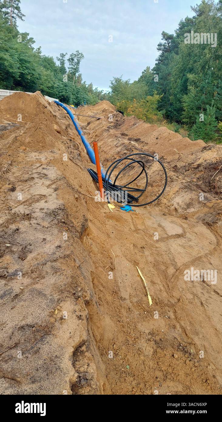 Pipeline construction: blue plastic drinking water pipeline is laid in ...