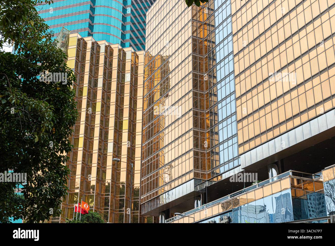 A modern golden building viewed from Kowloon Park, Kowloon, Hong Kong ...