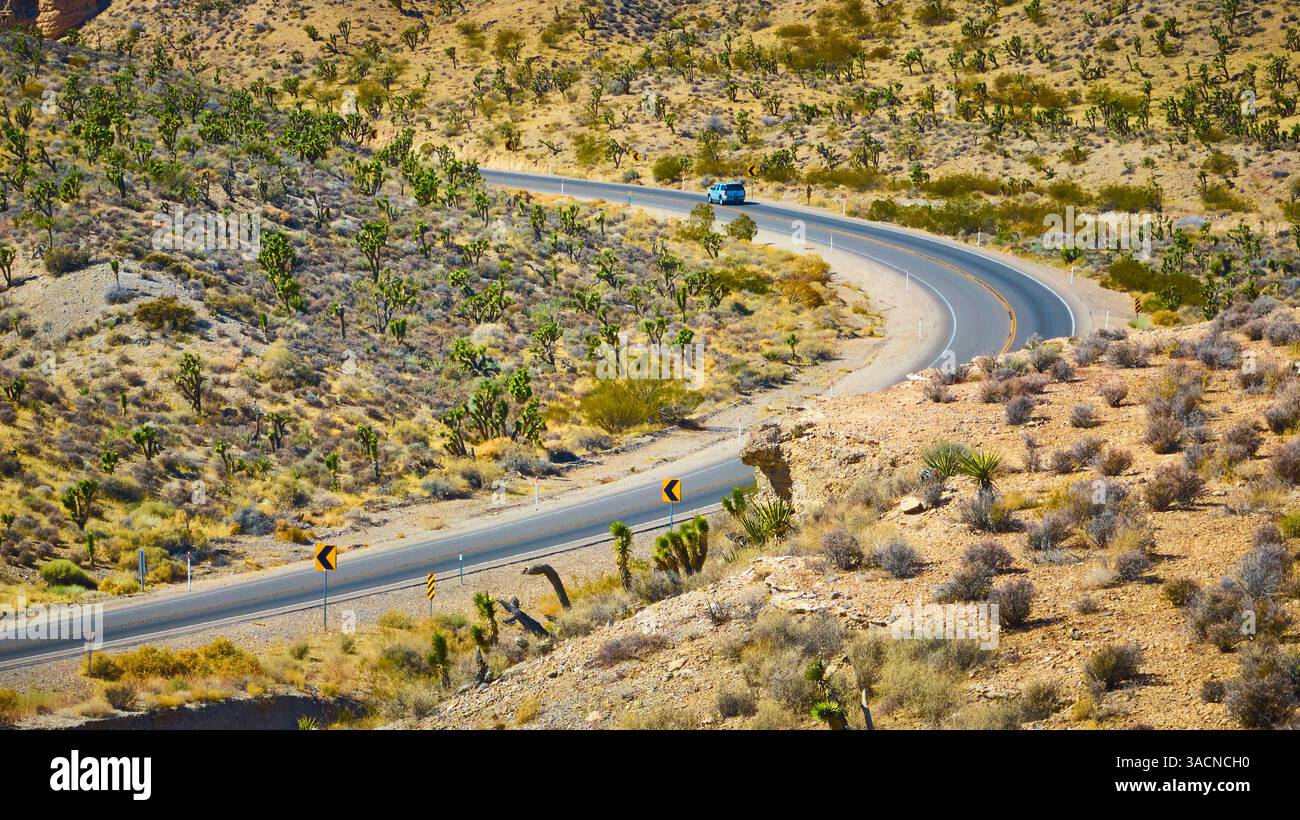 Aerial of Winding Desert Road with Blue Car in Nevada Stock Photo - Alamy