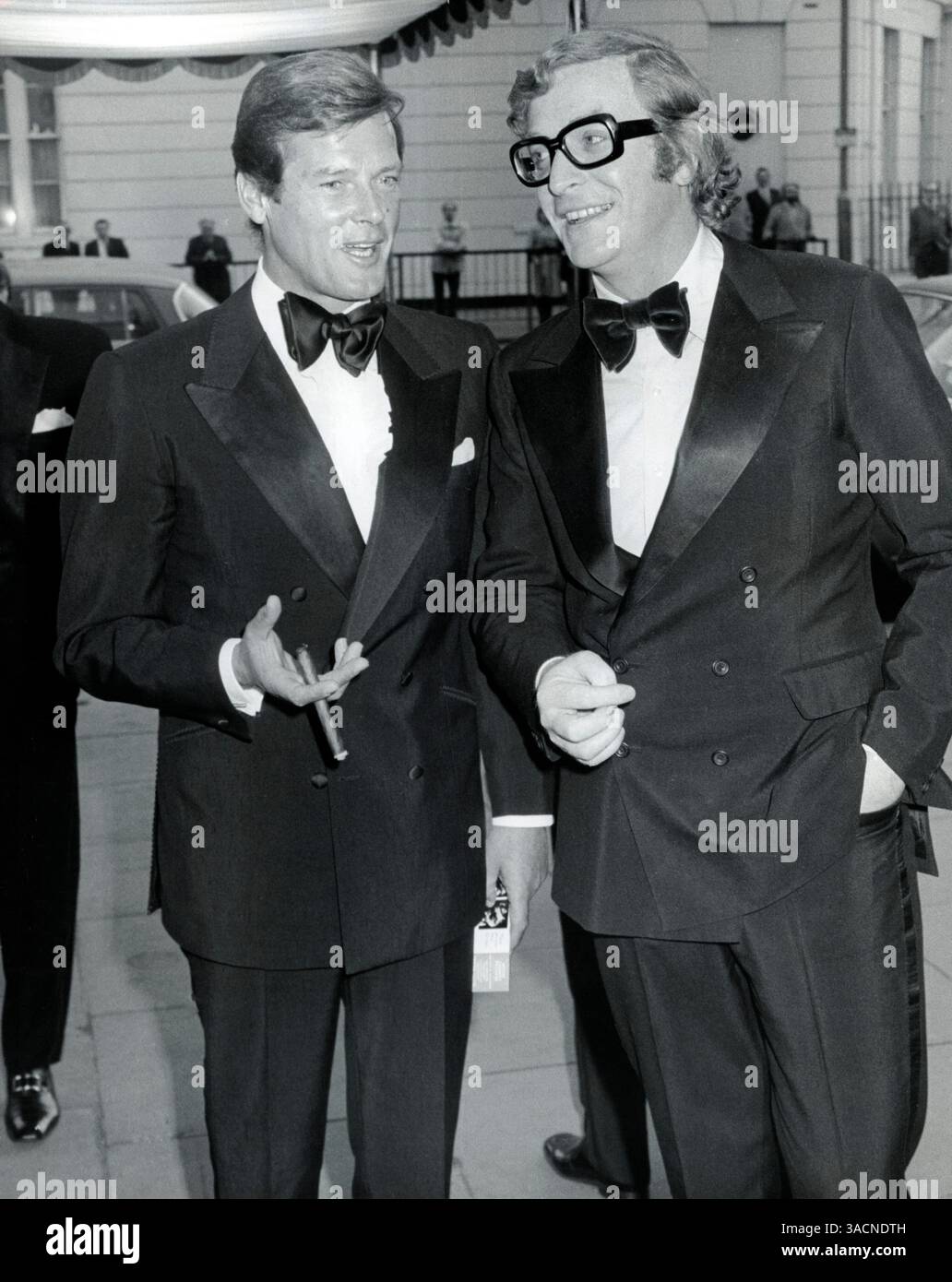 Michael Caine and Roger Moore attending a charity benefit premiere of ...