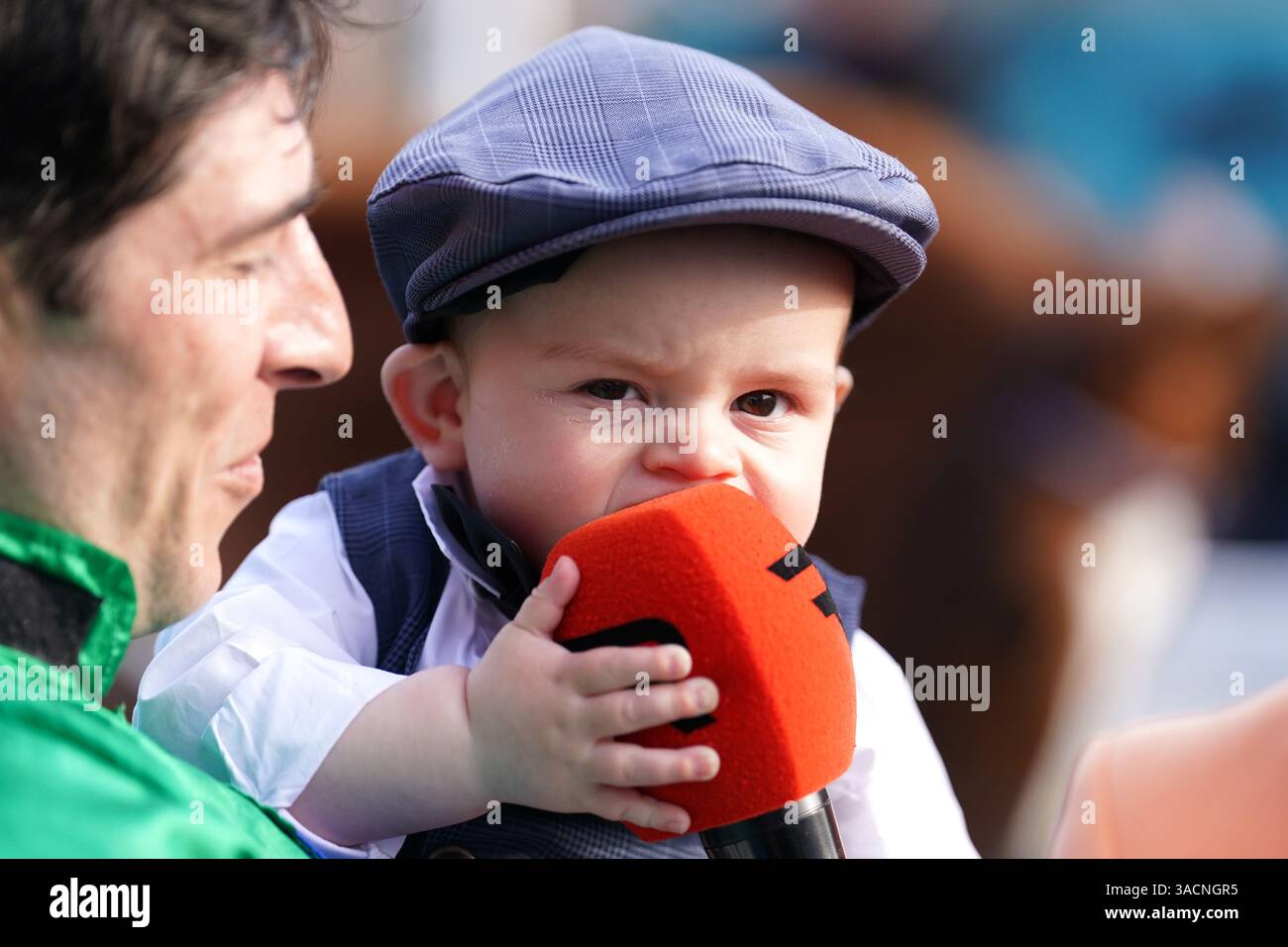 Gavin Sheehan with his son Teddy Sheehan, who attempts to bite a mic ...