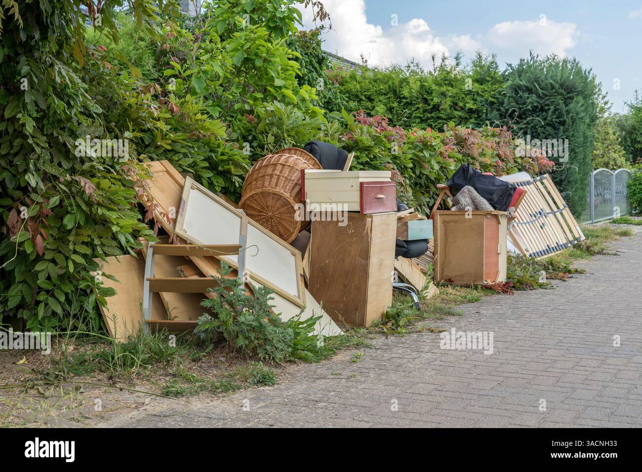Pile of bulky waste on the roadside with wooden furniture, drawers ...